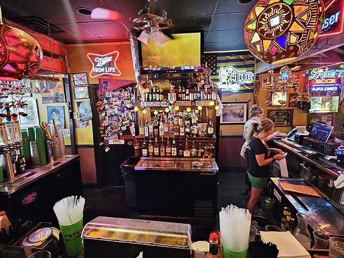 Behind the bar, where the magic happens. Those neon signs aren't just decoration &ndash; they're beacons guiding hungry souls to salvation.