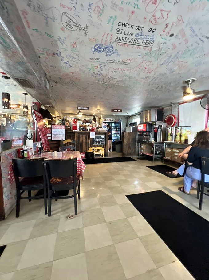 Where the magic happens&mdash;an interior that says "focus on the food, not the frills." The ceiling of customer signatures tells the real story of this place.
