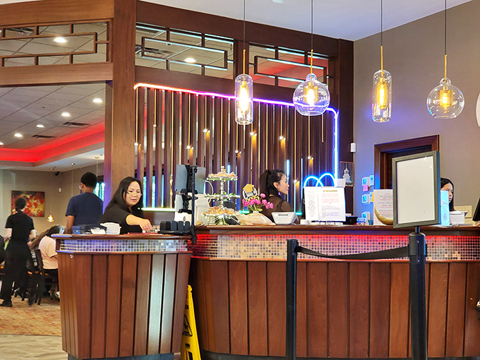 Staff members orchestrate the dining experience from behind a counter that pulses with light&mdash;the command center of comfort food operations.