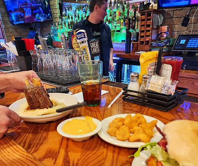 Behind every great meal is a team that makes the magic happen. The bar's impressive lineup of bottles promises adventures beyond just food.