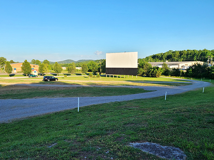 Daytime reveals the simple beauty of this outdoor theater, where gravel paths and green fields await the evening's transformation into movie magic.