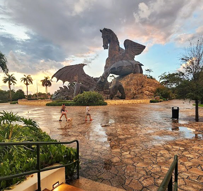 Rain-slicked pavers create a mirror effect at sunset, doubling the drama of this already theatrical roadside attraction.