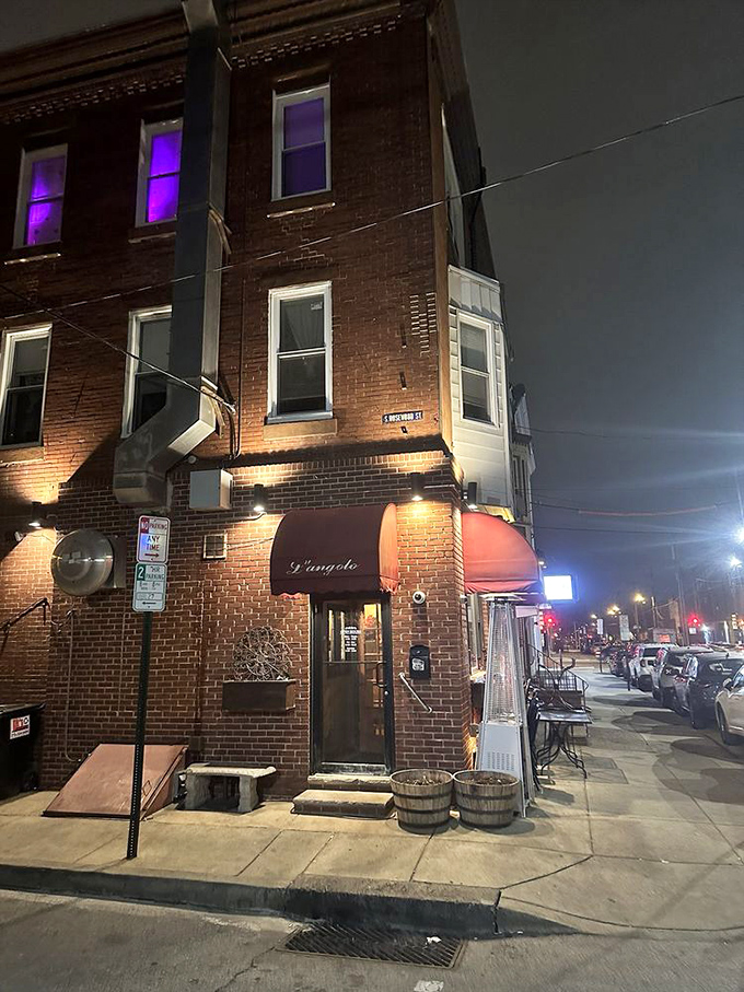 By night, L'Angolo glows like a beacon for those seeking authentic Italian flavors. That red awning becomes a culinary lighthouse guiding hungry ships to shore.