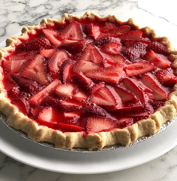 A strawberry pie so fresh and vibrant, it's practically announcing summer's arrival with every glistening berry.