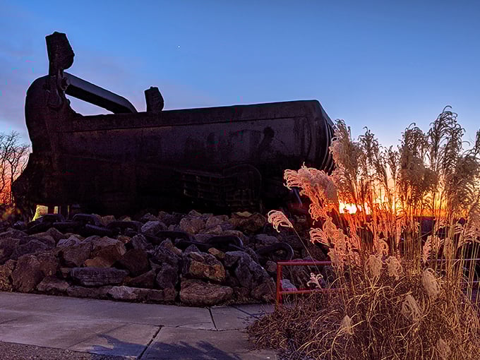 Sunset transforms the rusted giant into a silhouette against the fiery sky, a poetic end to a day of industrial tourism.