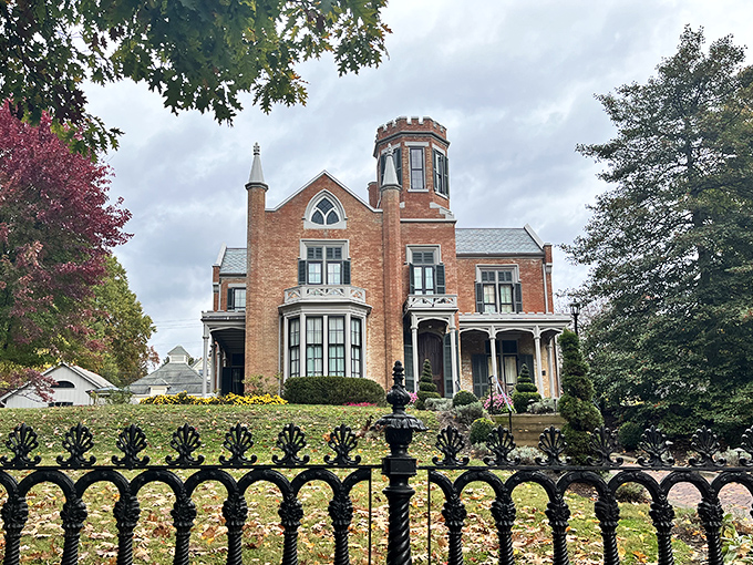 The Castle's Gothic Revival splendor rises behind ornate iron fencing, promising visitors a glimpse into Victorian opulence and 19th-century living.