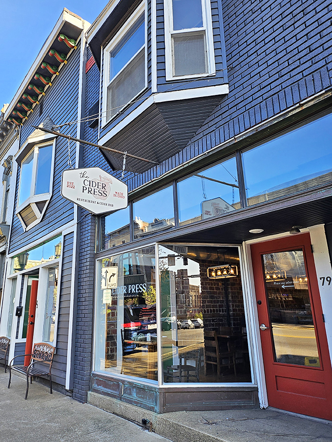 The Cider Press's navy blue facade and red doors pop against Millersburg's streetscape, promising local flavors with a side of small-town charm.