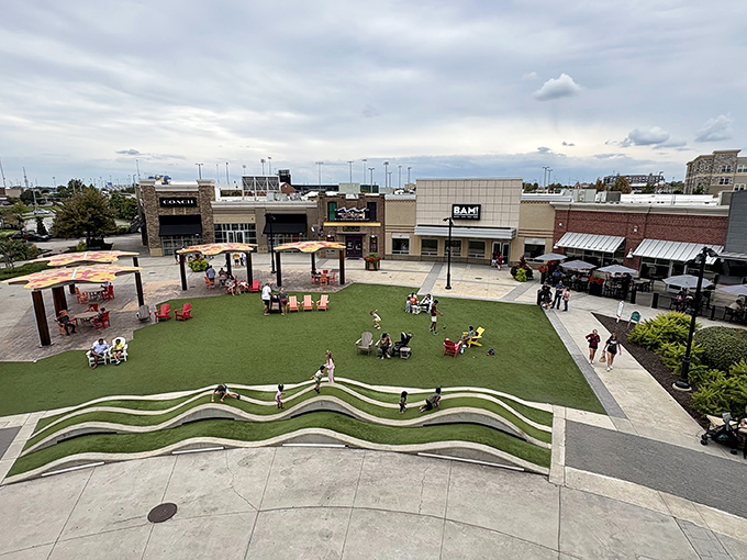 The central lawn area&mdash;retail therapy's intermission space, where shoppers regroup, children burn energy, and partners check sports scores on their phones.
