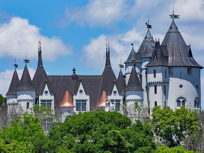 Castle Gwynn's distinctive silhouette rises above the treetops, its towers and turrets creating a skyline that belongs more in Wales than Tennessee.