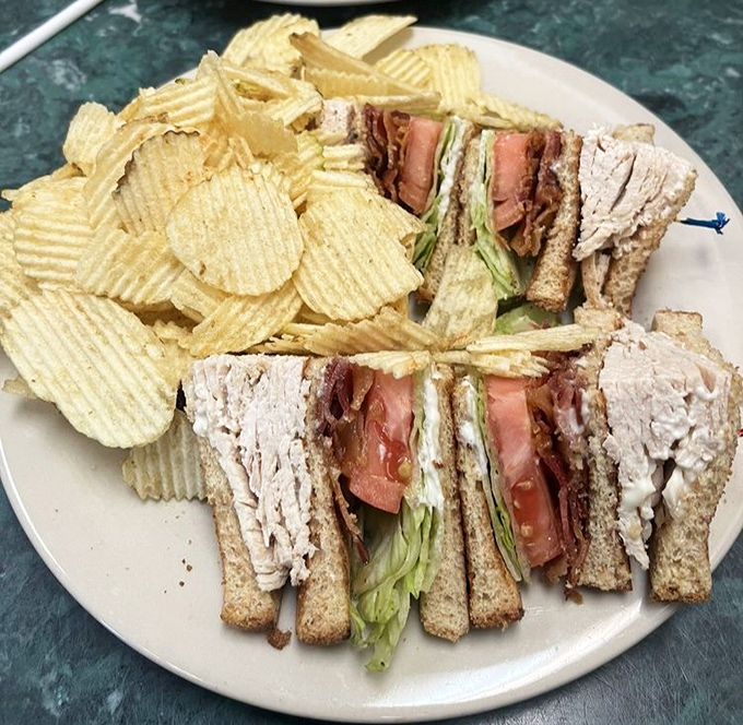 The club sandwich &ndash; mankind's greatest architectural achievement since the pyramids, stacked high enough to require strategic planning before each bite.