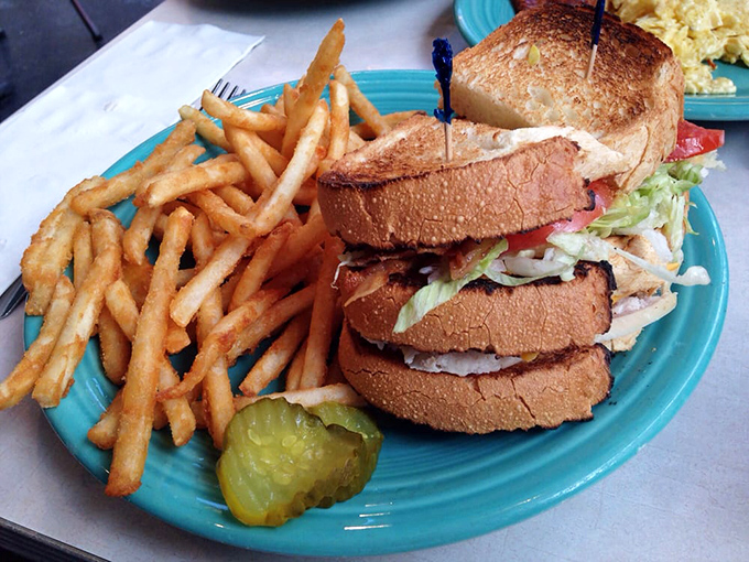 The turkey club stands tall and proud, proving lunch items can hold their own in this breakfast kingdom.