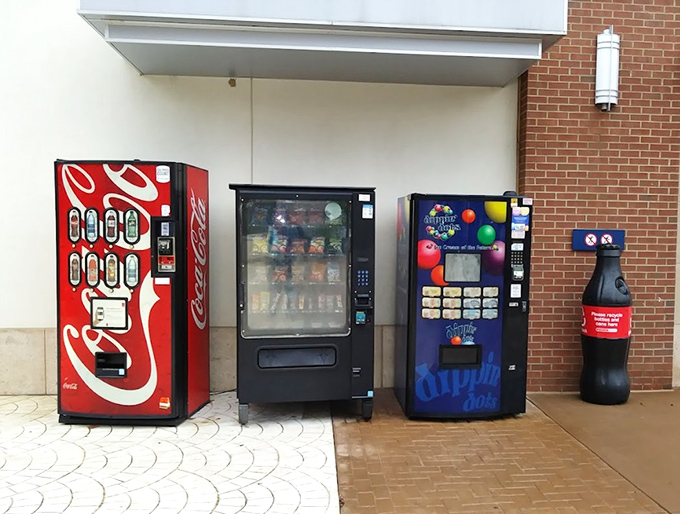 Vending machines: the unsung heroes of outlet shopping. When hunger strikes mid-bargain hunt, these mechanical saviors stand ready with caffeinated reinforcements.