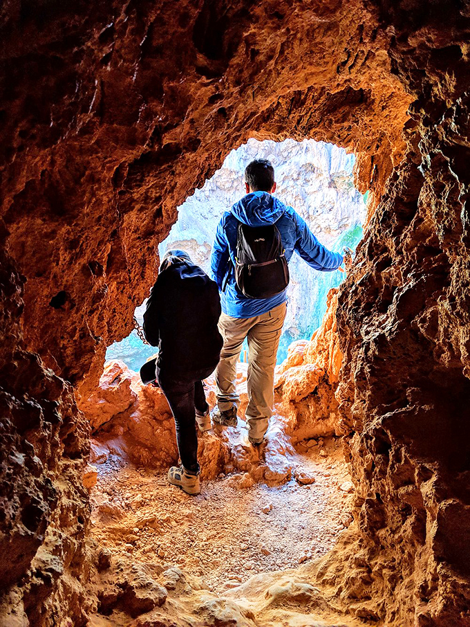 Hikers emerge from tunnel passages looking equal parts triumphant and relieved to see daylight again.