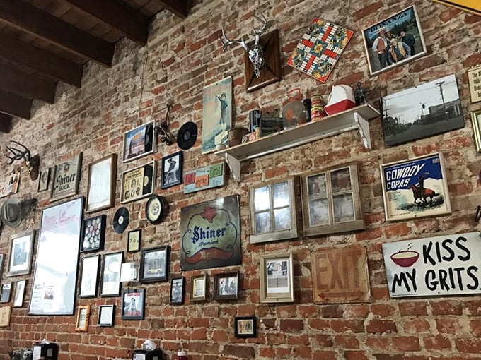 "Kiss My Grits" isn't just a wall decoration&mdash;it's practically the Texas state motto. This wall tells more stories than your grandpa after two beers.