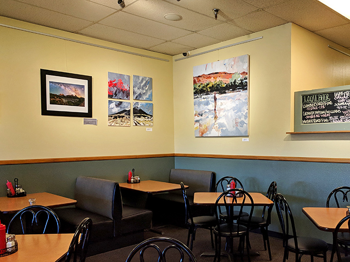 Colorful local art adorns butter-yellow walls – visual appetizers while you wait for the main event.