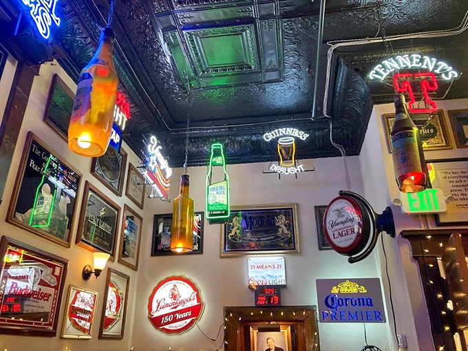 Beer signs and memorabilia create a museum of American drinking culture, glowing with the warm invitation of places that understand hospitality.