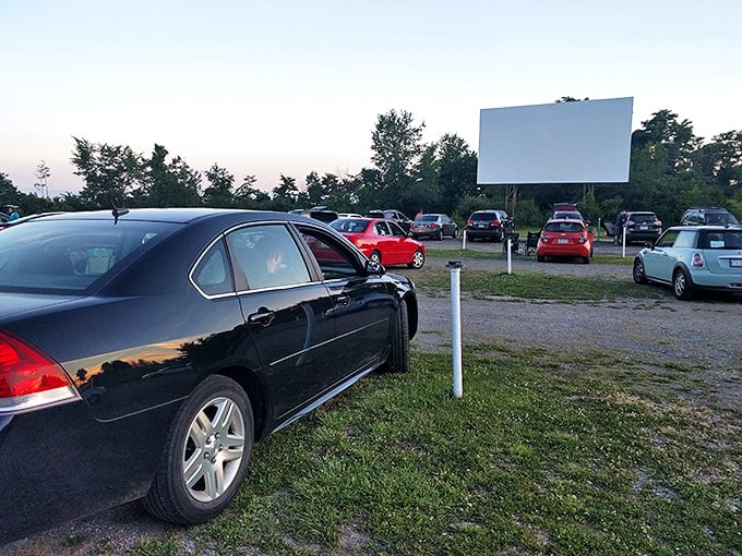 As twilight settles in, the screen stands sentinel against the darkening sky. The transition from day to night is half the show.