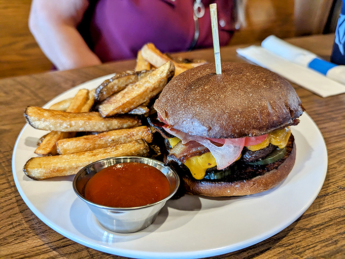 A burger that requires strategic planning before the first bite—note the perfect cheese melt that's practically winking at you.