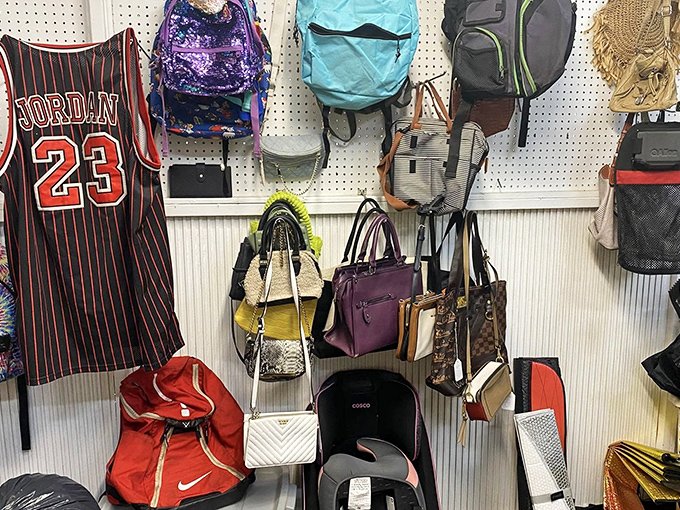 Bag bonanza featuring everything from designer purses to practical backpacks. That Michael Jordan jersey hanging nearby is the real MVP of this display.