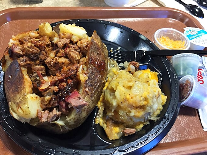 The loaded baked potato &ndash; a magnificent vessel for delivering more barbecue to your face. It's not just a side; it's a strategy.