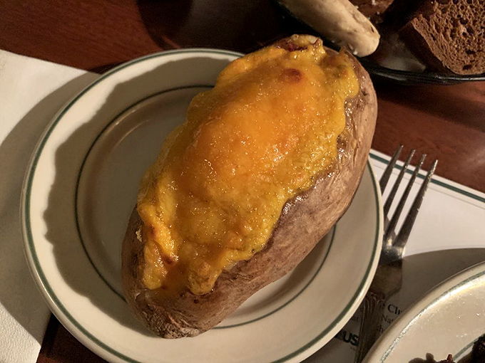 The humble baked potato, elevated to art form. That melted cheese blanket is the comfort food equivalent of a warm hug.