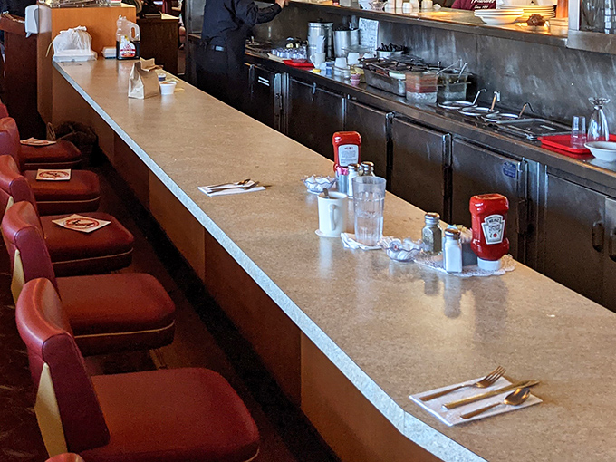 The counter stretches like a runway for food fashion, where red vinyl stools await diners eager for their next memorable meal.