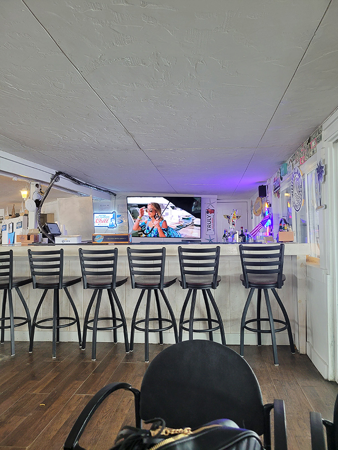 The bar area provides front-row seats to the seafood show, where cold drinks and warm conversation flow as freely as the nearby tides.