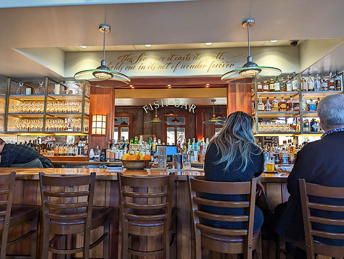 The bar at The Fishery &ndash; where maritime meets mixology under warm lighting. The perfect spot to contemplate your next seafood adventure.