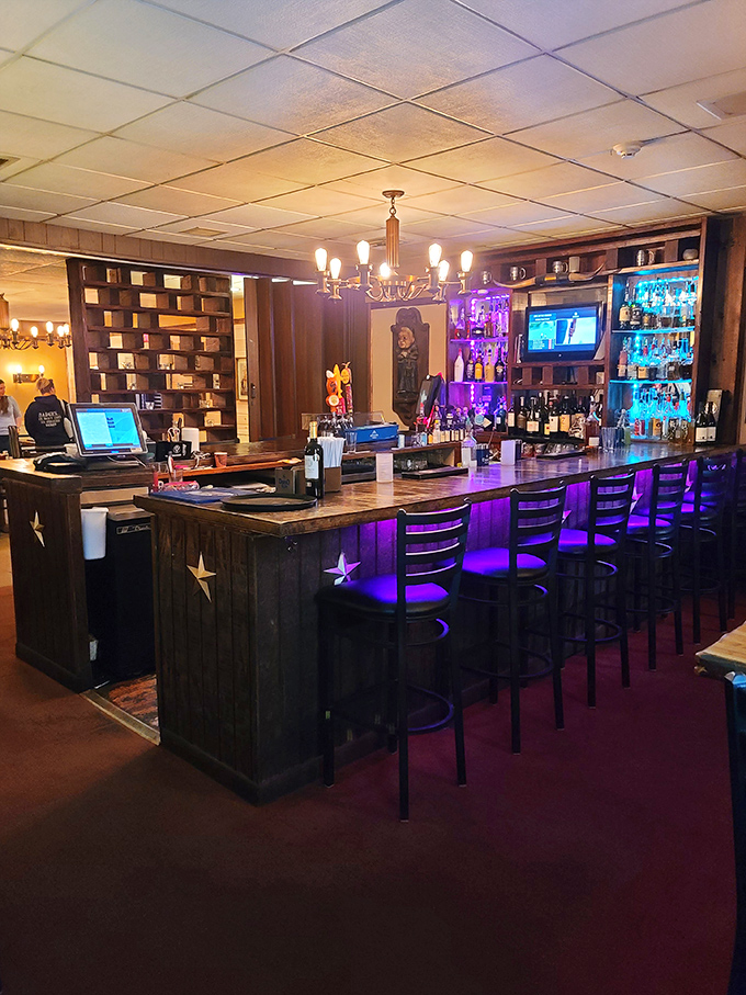 The bar isn't just where drinks are served&mdash;it's command central for evening enjoyment. Those purple lights set the mood for stories that get better with each round.