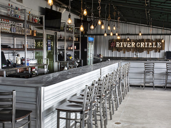 Industrial-chic bar design that says "we're serious about our drinks" without being pretentious about it. Edison bulbs add the perfect glow.