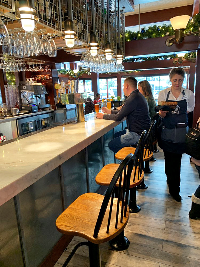 The bar isn't just where drinks are made&mdash;it's where stories are shared. Nautical-inspired lighting creates the perfect backdrop for seafood tales.