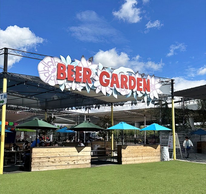 The Beer Garden beckons weary shoppers with the promise of cold brews and shady respite. Even the most dedicated bargain hunters need a refreshment intermission.