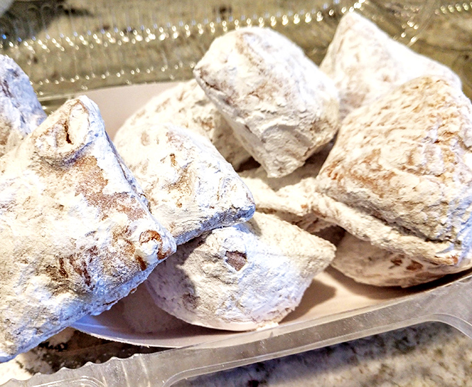 Powdered sugar pillows that collapse with a puff when bitten &ndash; leaving evidence on your shirt and joy in your soul.