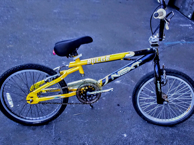BMX nostalgia on two wheels. This yellow Pulse bike could be someone's transportation restoration project or a kid's first taste of freedom.