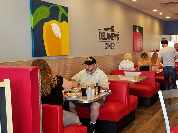 Those red booths aren't just seating&mdash;they're conversation incubators where strangers become friends over shared syrup bottles and coffee refills.