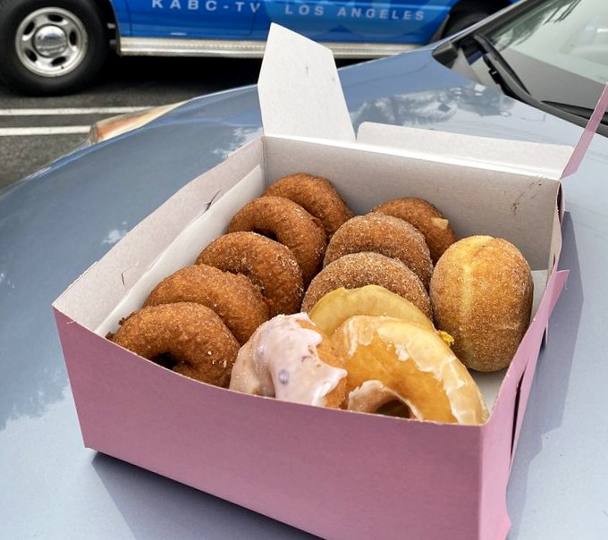 The iconic pink box—Los Angeles' most beloved container—filled with an assortment that makes sharing both necessary and slightly heartbreaking.