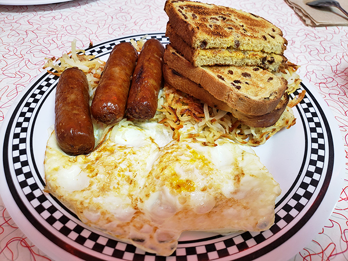 The classic American breakfast trifecta: perfectly cooked eggs, savory sausage links, and hash browns that steal the show.
