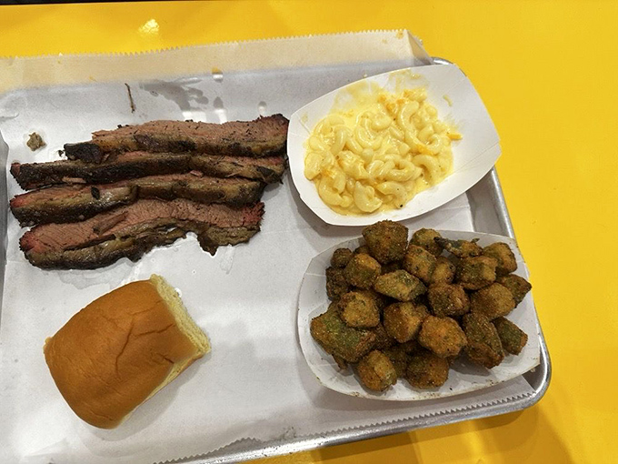Brisket slices, mac and cheese, and what appear to be fried okra &ndash; the holy trinity of Southern comfort arranged on a tray of joy.