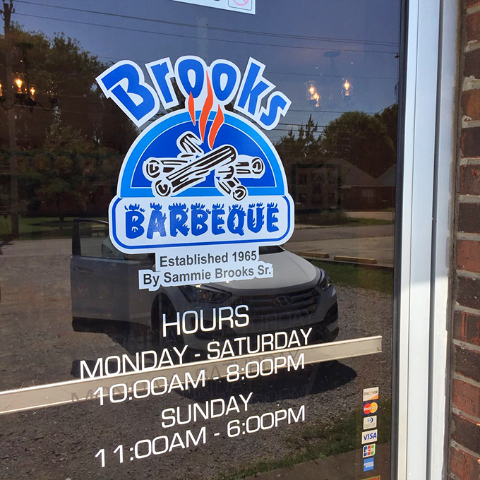 The door sign reveals Brooks' barbecue wisdom has been slow-smoking since 1965&mdash;when patience wasn't just a virtue but a cooking method.