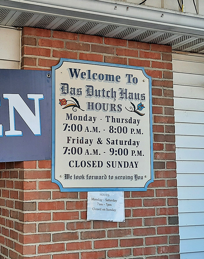 Business hours posted with old-world charm&mdash;the kind of sign that politely says "plan accordingly" while looking absolutely delightful.
