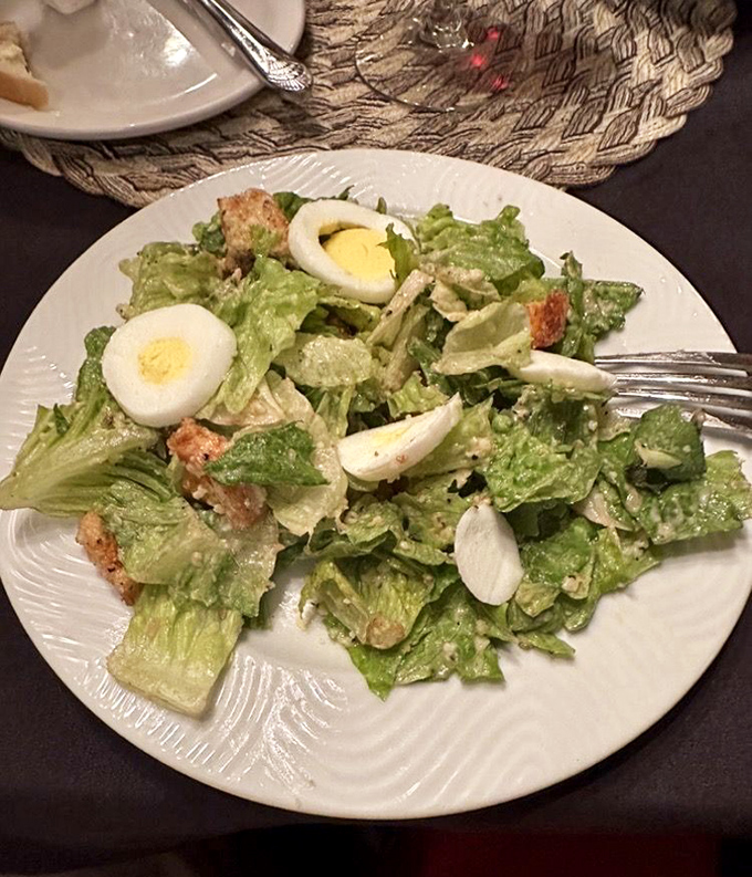 A Caesar salad that Julius himself would approve of&mdash;crisp romaine, perfect dressing distribution, and those eggs adding a touch of richness.