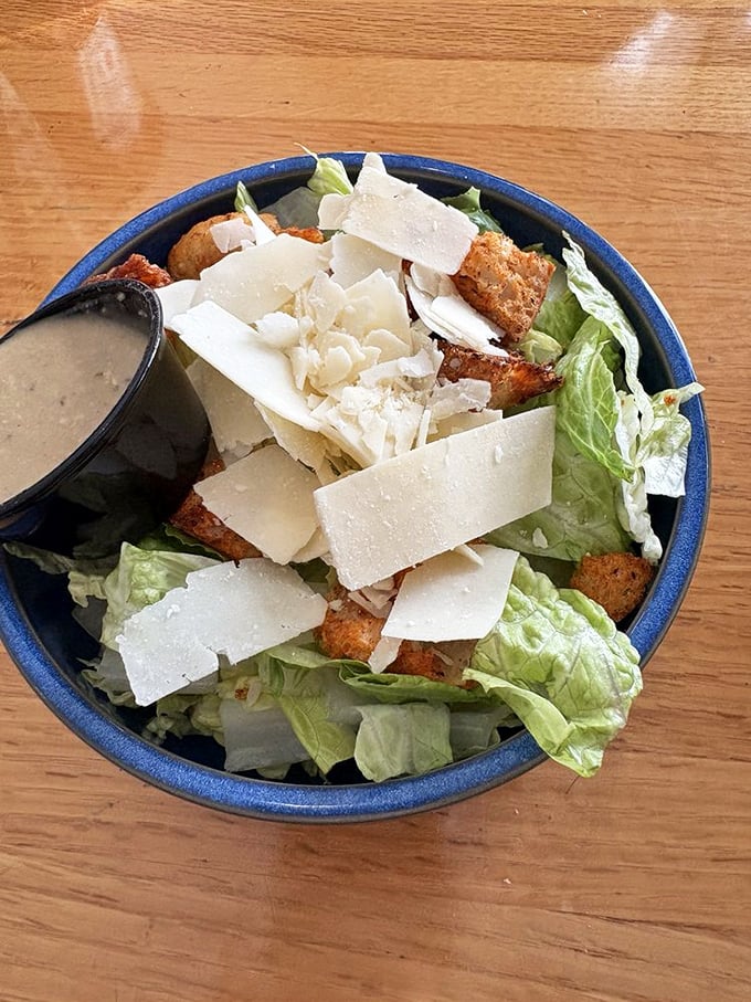 Crisp romaine gets the royal treatment with generous parmesan shavings and perfectly seasoned homemade croutons.