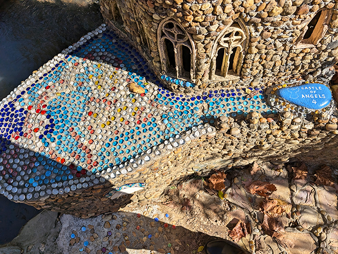 A fish mosaic swimming alongside a miniature castle. Because why settle for a boring garden gnome when you can have an entire aquatic kingdom?