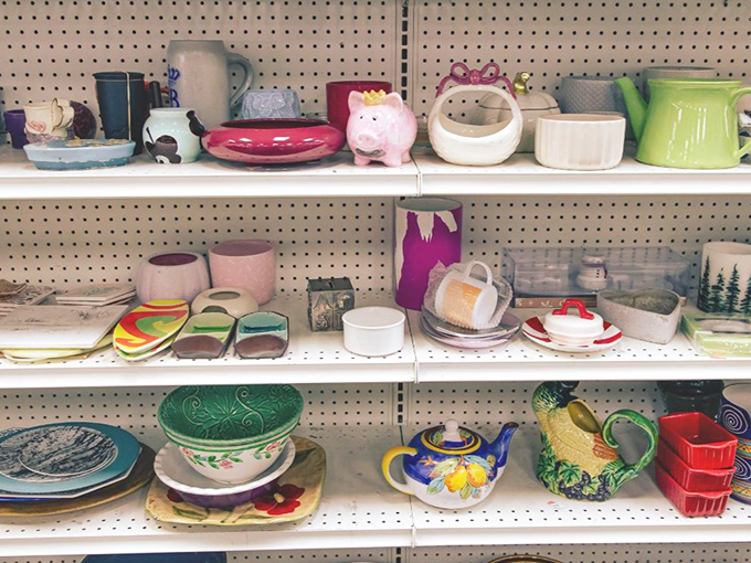 Ceramic treasures and kitchen oddities share shelf space in a colorful display that celebrates both function and quirky charm equally well.