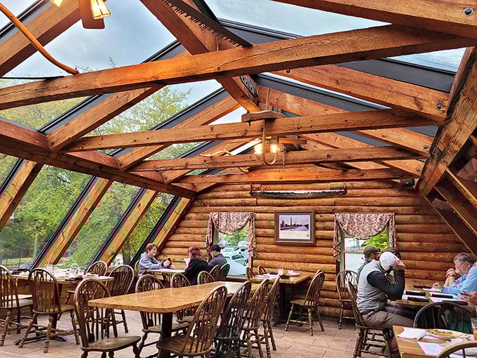 Sunlight streams through skylights in this log cabin dining room, where barbecue pilgrims gather like at a delicious family reunion.