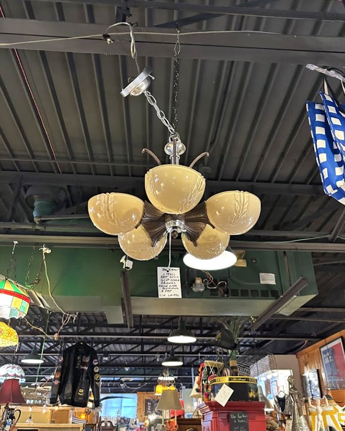 This mid-century chandelier with its amber bowls once cast a warm glow over family dinners where "Instagram-worthy" wasn't yet a concept.
