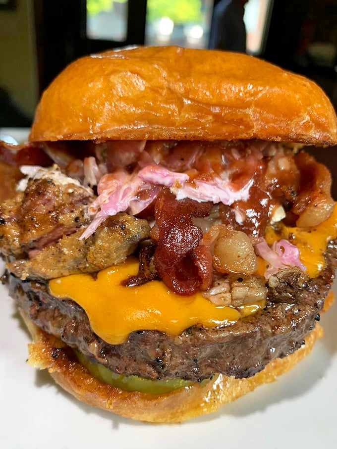 This burger towers with layers of bacon, pulled pork, and cheese, basically daring you to figure out the proper angle of attack.