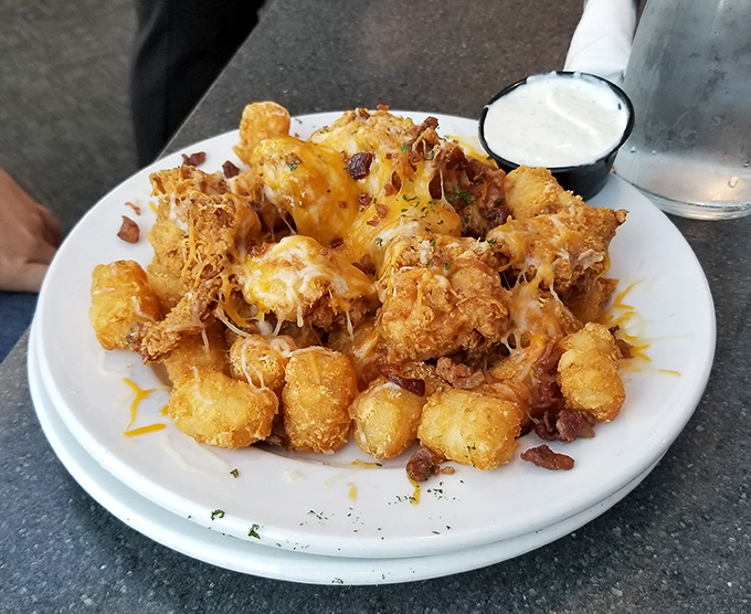 Tater tots all grown up and living their best life. Bacon, cheese, and ranch dressing turned snack food into a celebration.