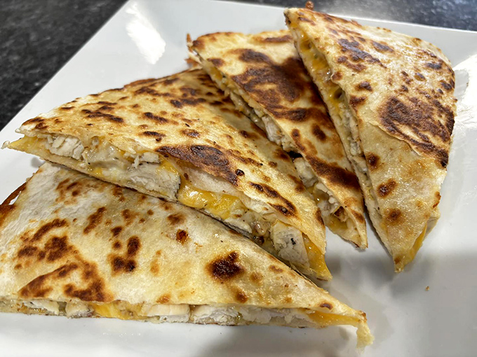 Quesadillas: where cheese meets tortilla in a hot, crispy romance that makes you wonder why you'd ever order anything else.