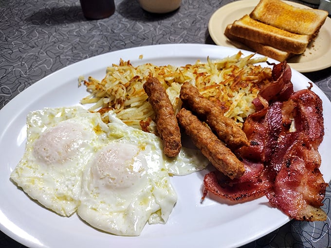 The breakfast trinity&mdash;eggs, bacon, and hash browns&mdash;performing in perfect harmony on a plate. Morning salvation has arrived.